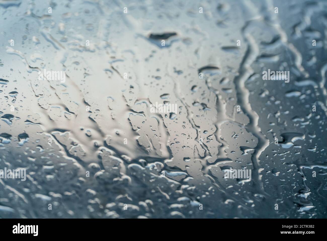 Background of water droplets on the windshield on a rainy evening with ...