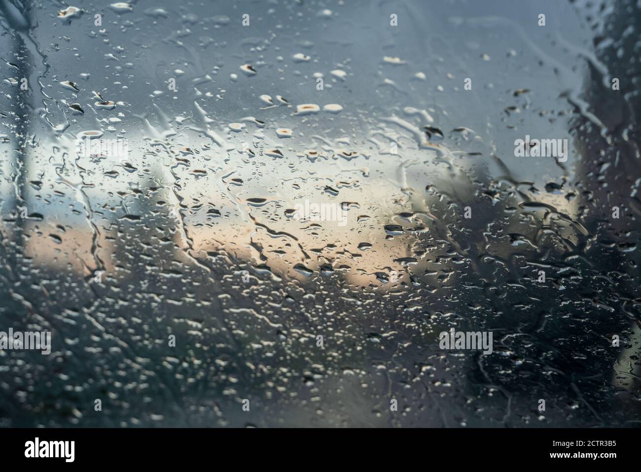 Background of water droplets on the windshield on a rainy evening with ...