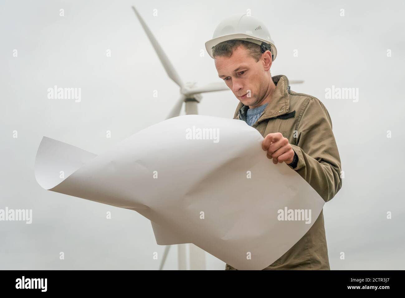 engineer examines the place with a plan in his hands. Project Manager ...
