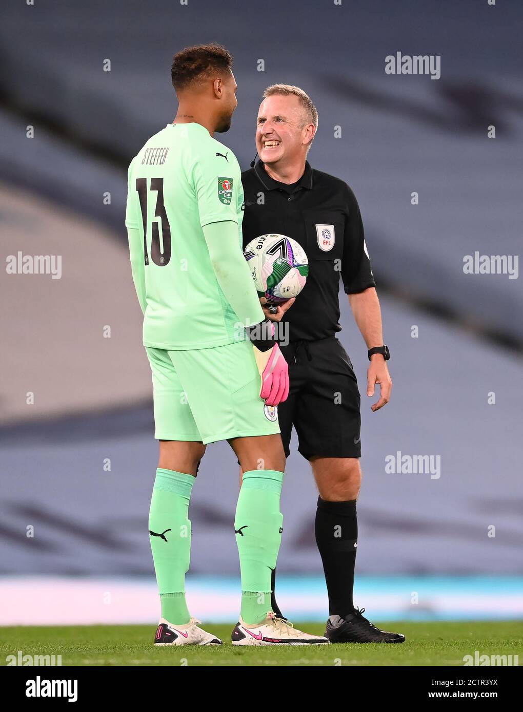 Match referee Jonathan Moss shares a joke with Manchester City ...