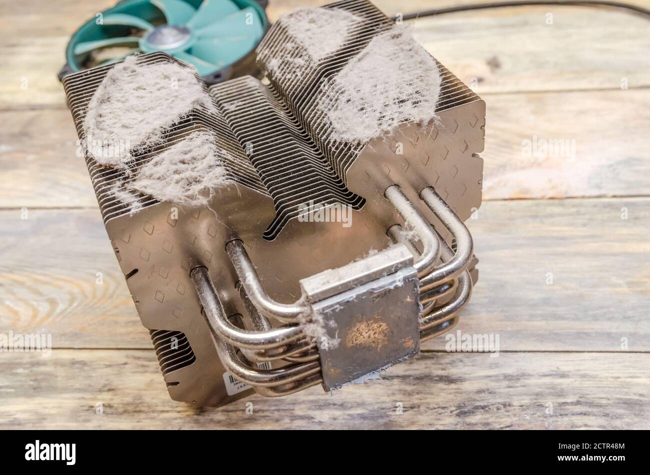Dirty dusty radiator computer processor close-up on a wooden table ...