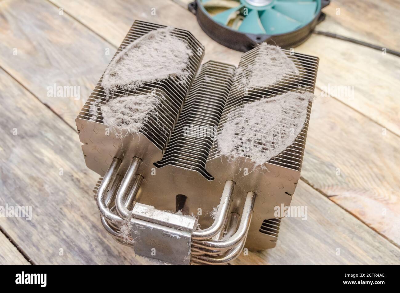 Dirty dusty radiator computer processor close-up on a wooden table ...