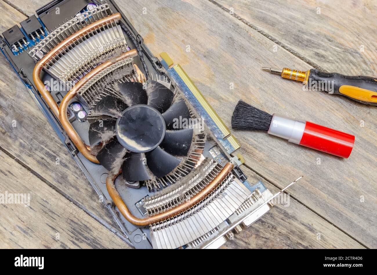 Dust on CPU cooler video card computer close up on wooden table ...