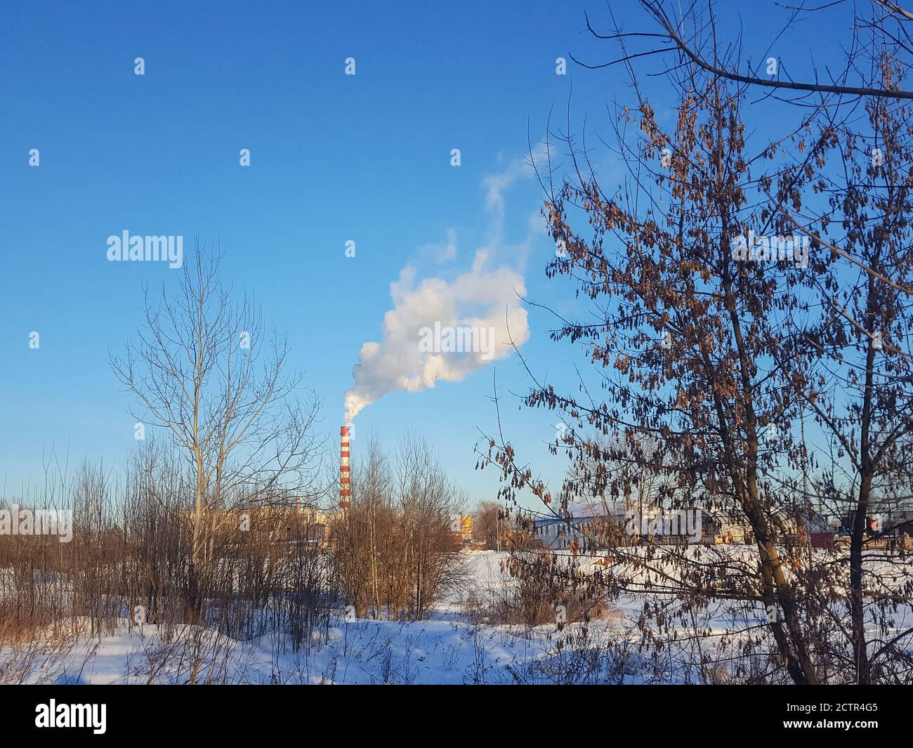 factory pipes with smoke in cold winter landscape. Pipes with smoke ...