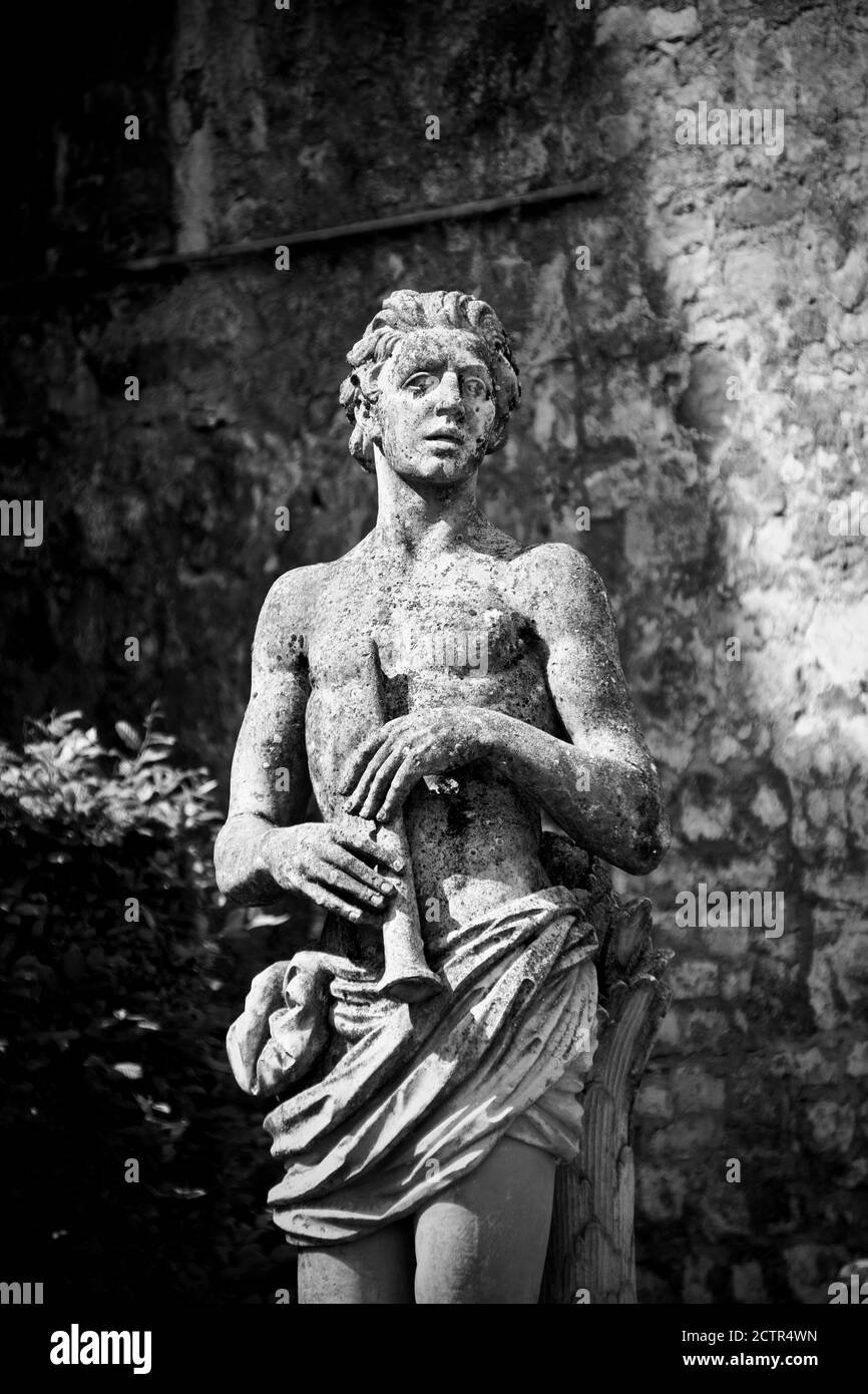 Black and white picture of a male statue with a flute in Würzburg ...