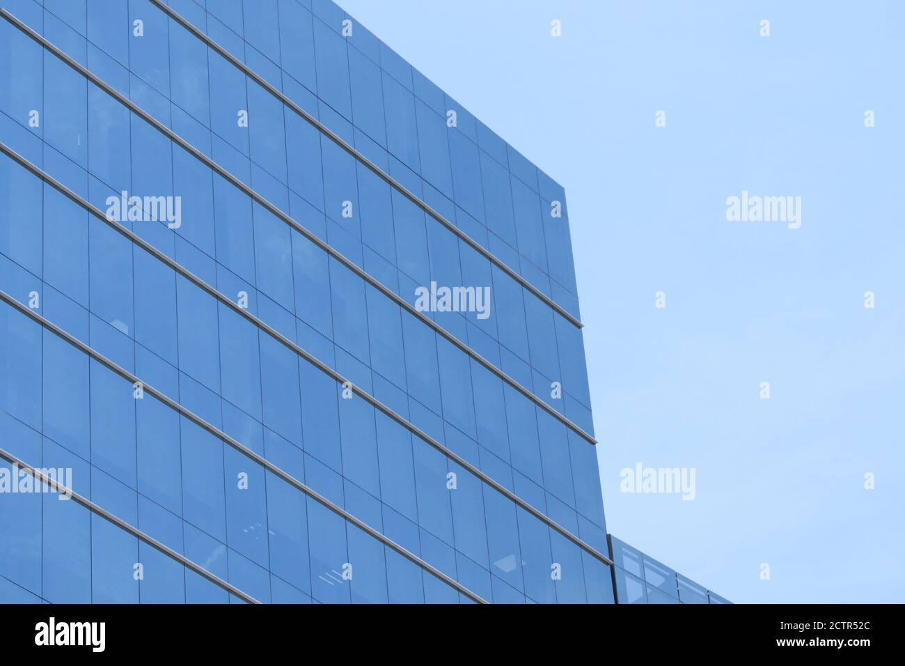 Low angle shot of a tall glass building at daytime Stock Photo - Alamy
