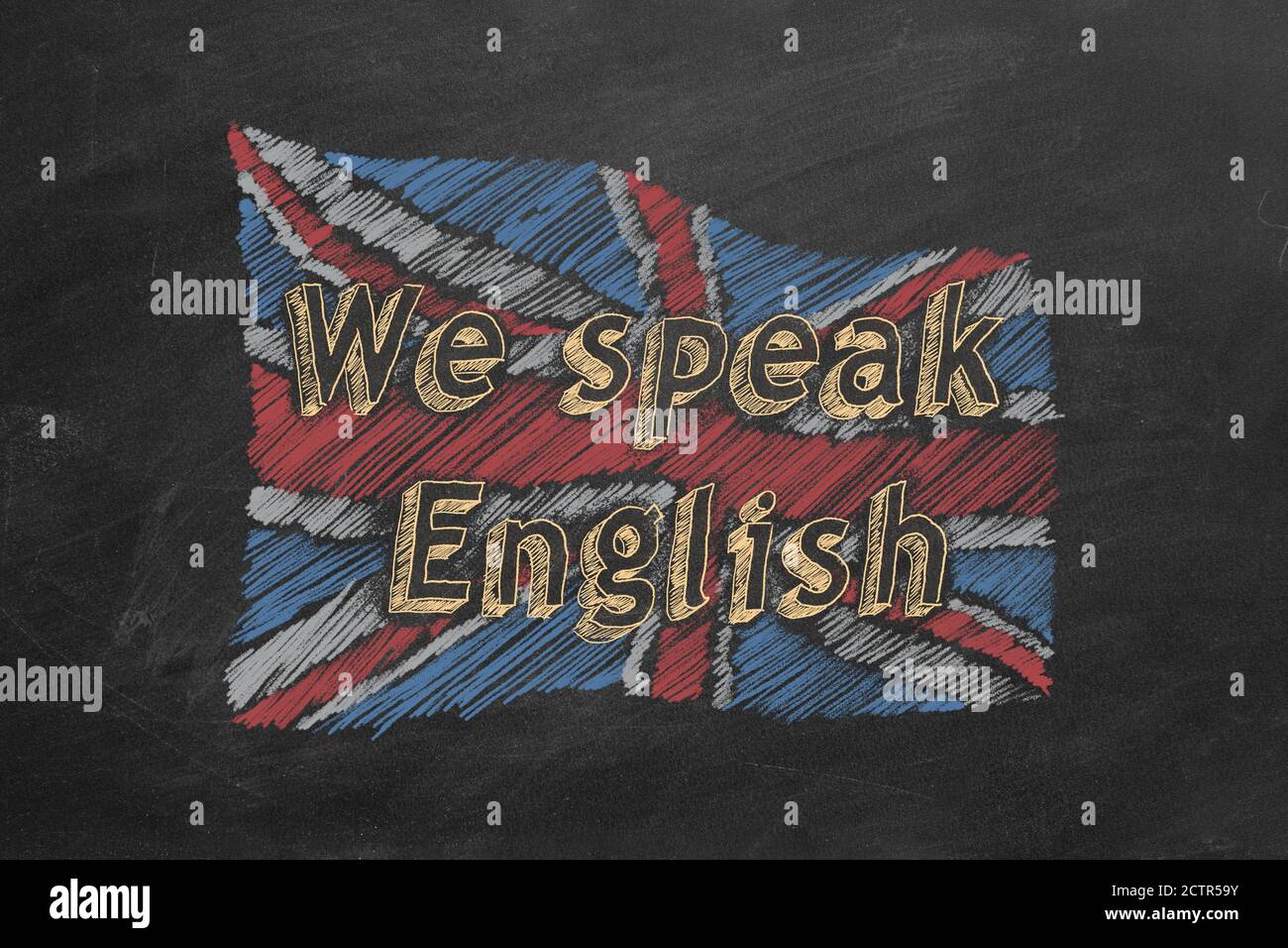 Hand drawing british flag with text "We speak English" on blackboard ...