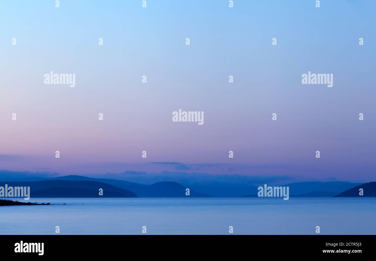 View of the surrounding hills, sea in nightfall. Night and colorful sky ...