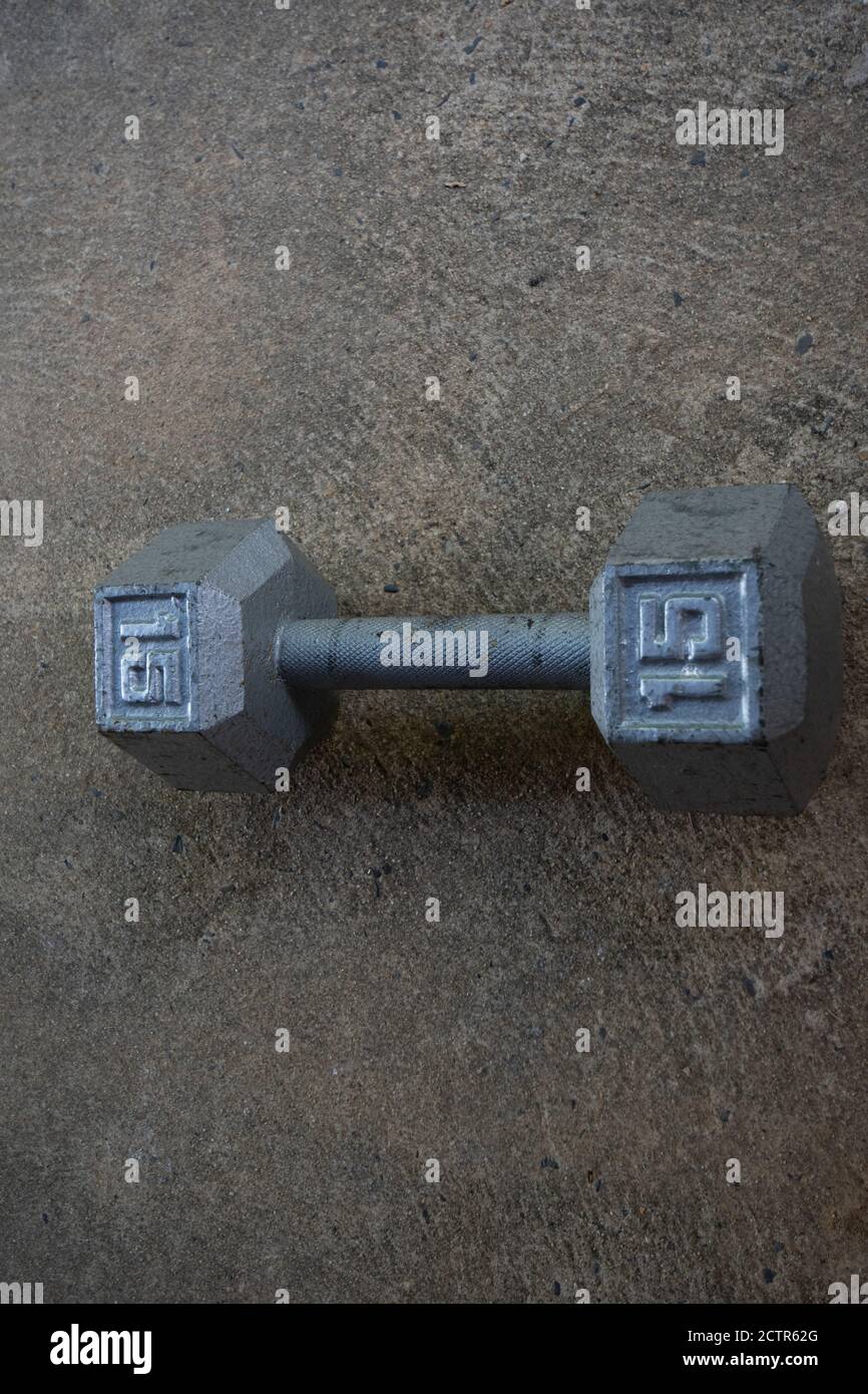 An Old Silver Fifteen Pound Weight on Concrete Stock Photo - Alamy