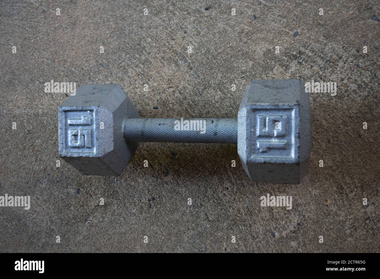 An Old Silver Fifteen Pound Weight on Concrete Stock Photo - Alamy