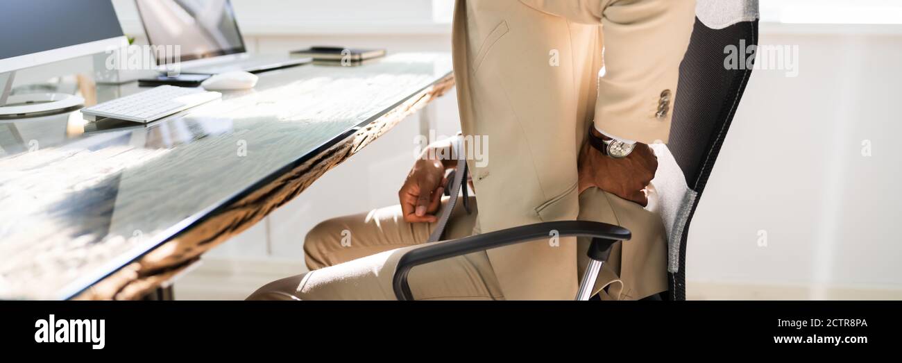 Back Pain Sitting In Bad Posture Using Computer Stock Photo - Alamy