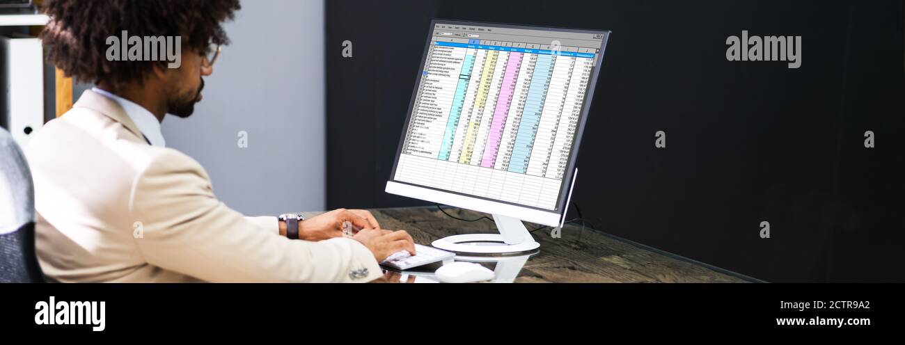 Analyst Employee Working With Spreadsheet On Computer Stock Photo - Alamy