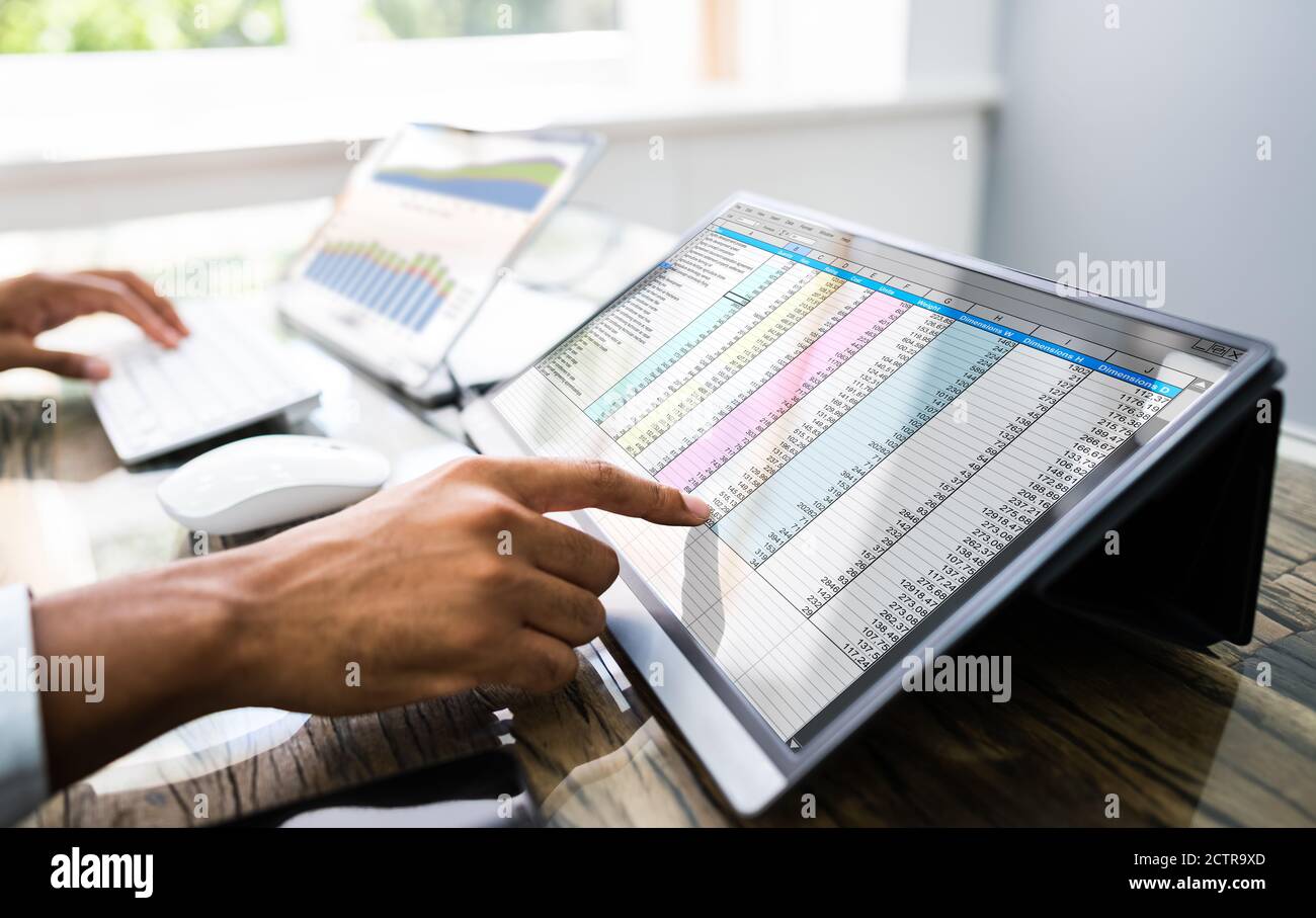 Analyst Working With Spreadsheet Data On Computer Stock Photo - Alamy