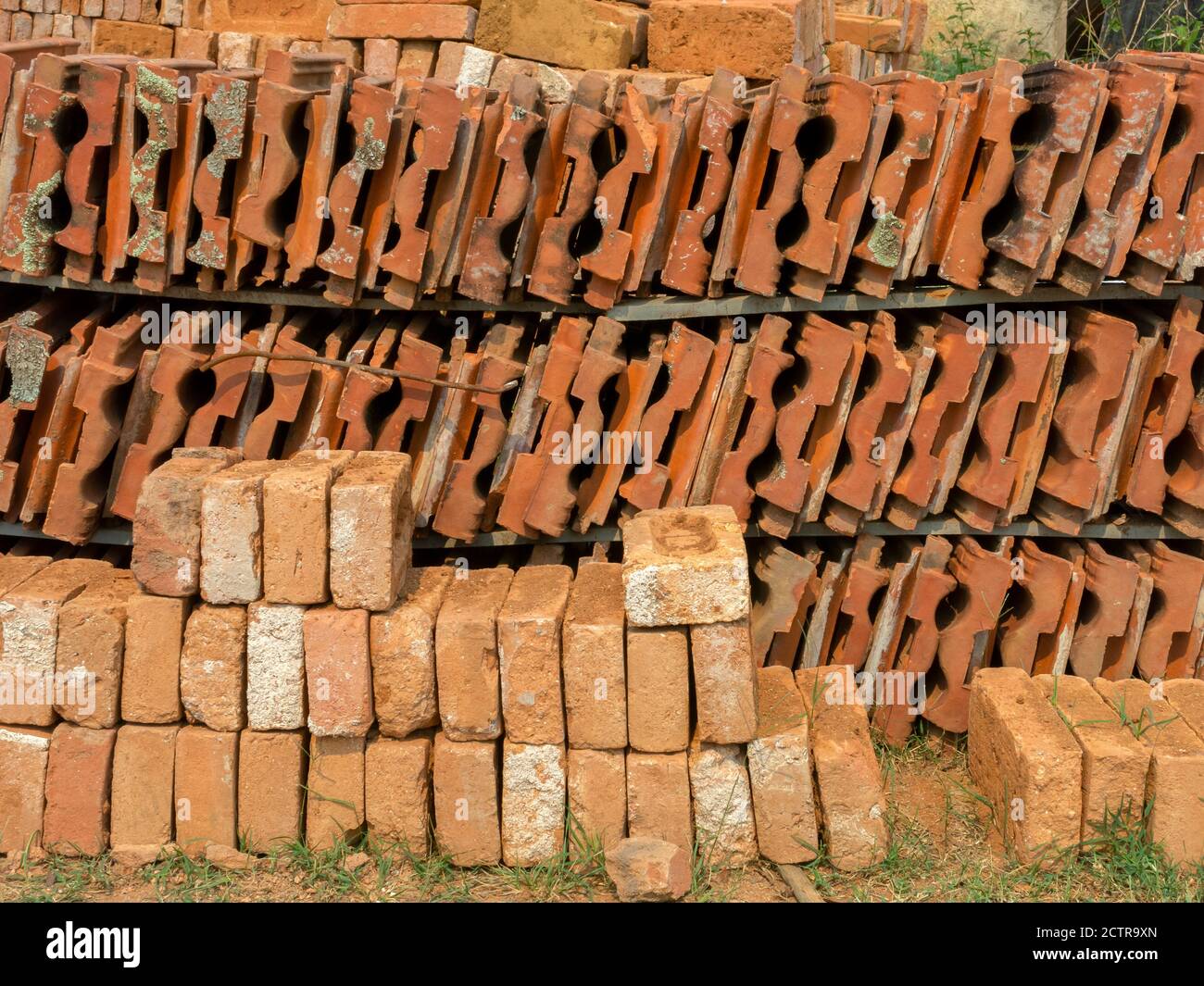 Stacked used clay brick and roof tile for reuse Stock Photo - Alamy