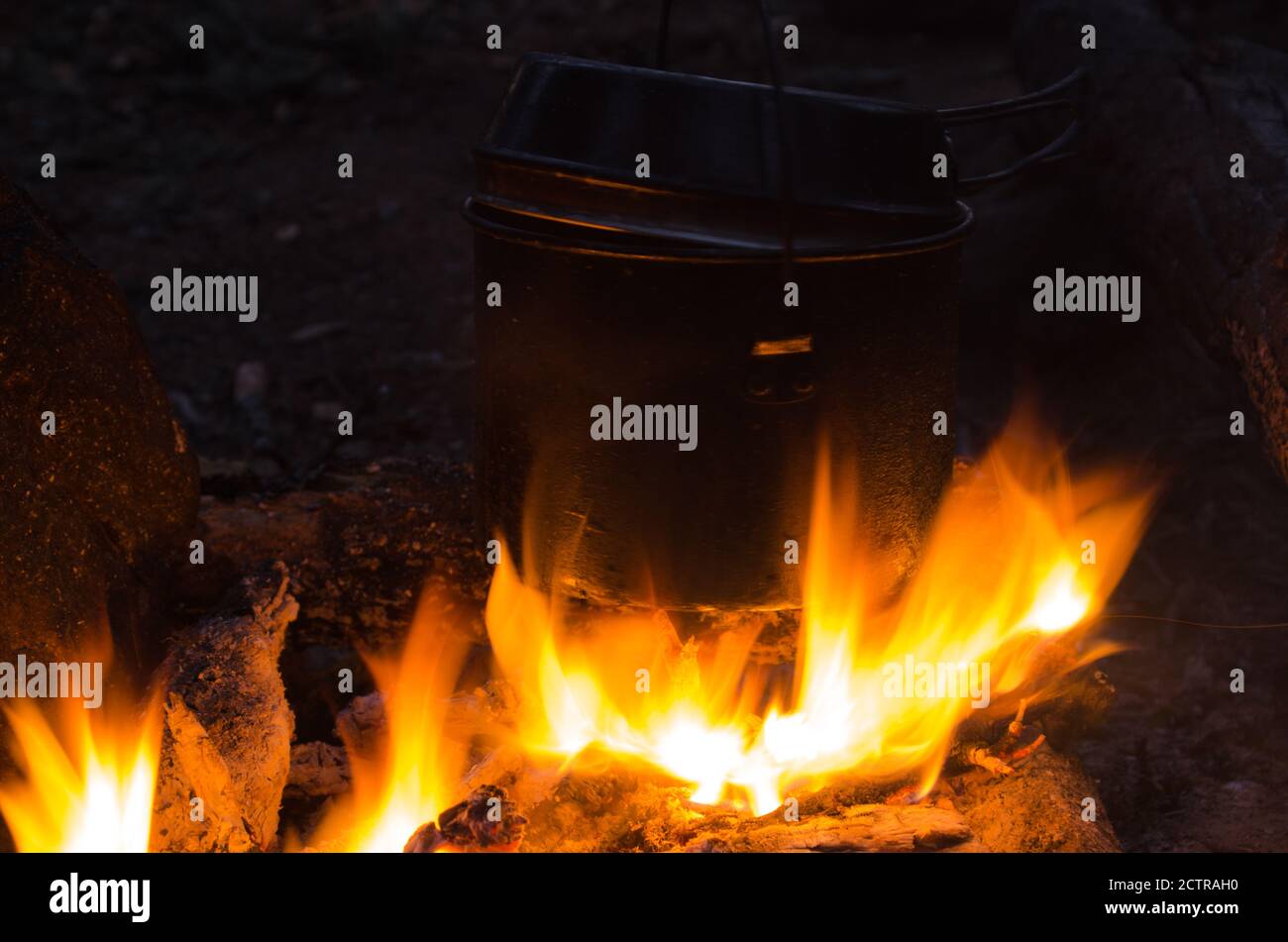 fire burns in the campaign. pot of tea by the fire Stock Photo - Alamy