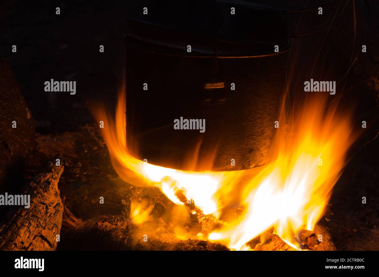 fire burns in the campaign. pot of tea by the fire Stock Photo - Alamy