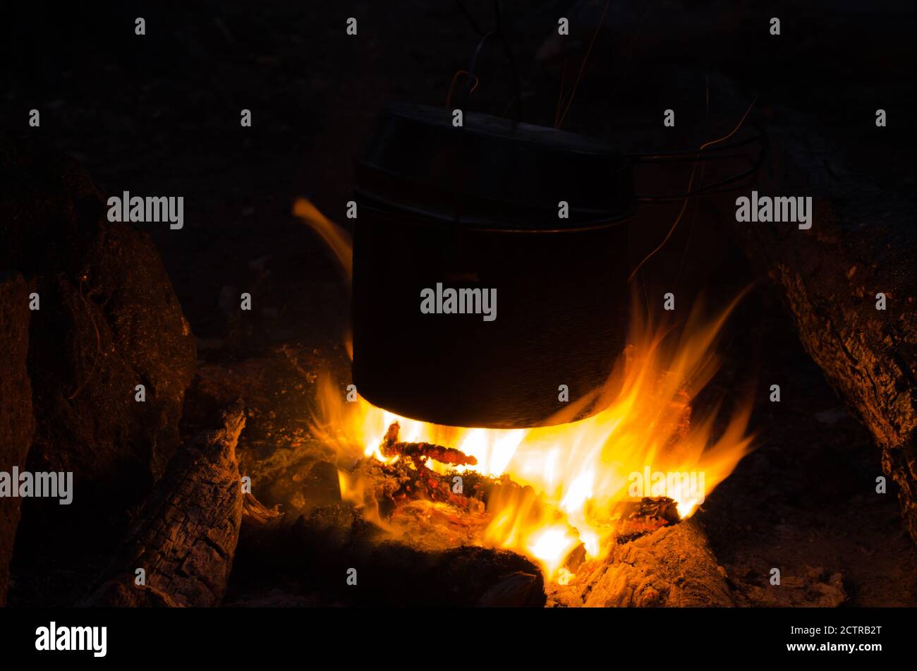 fire burns in the campaign. pot of tea by the fire Stock Photo - Alamy