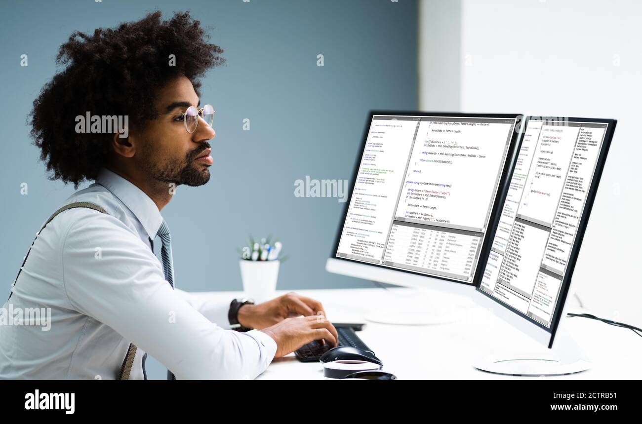 Work From Home On Multiple Computer Screen. African Programmer Stock ...
