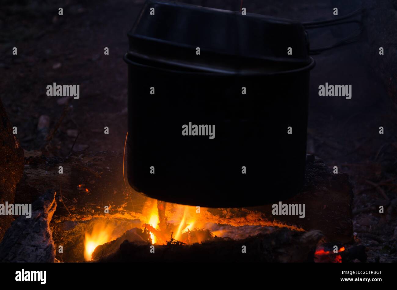 fire burns in the campaign. pot of tea by the fire Stock Photo - Alamy