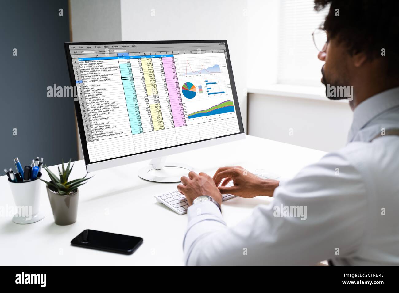 Young Man Working On Spreadsheet High Resolution Stock Photography and ...