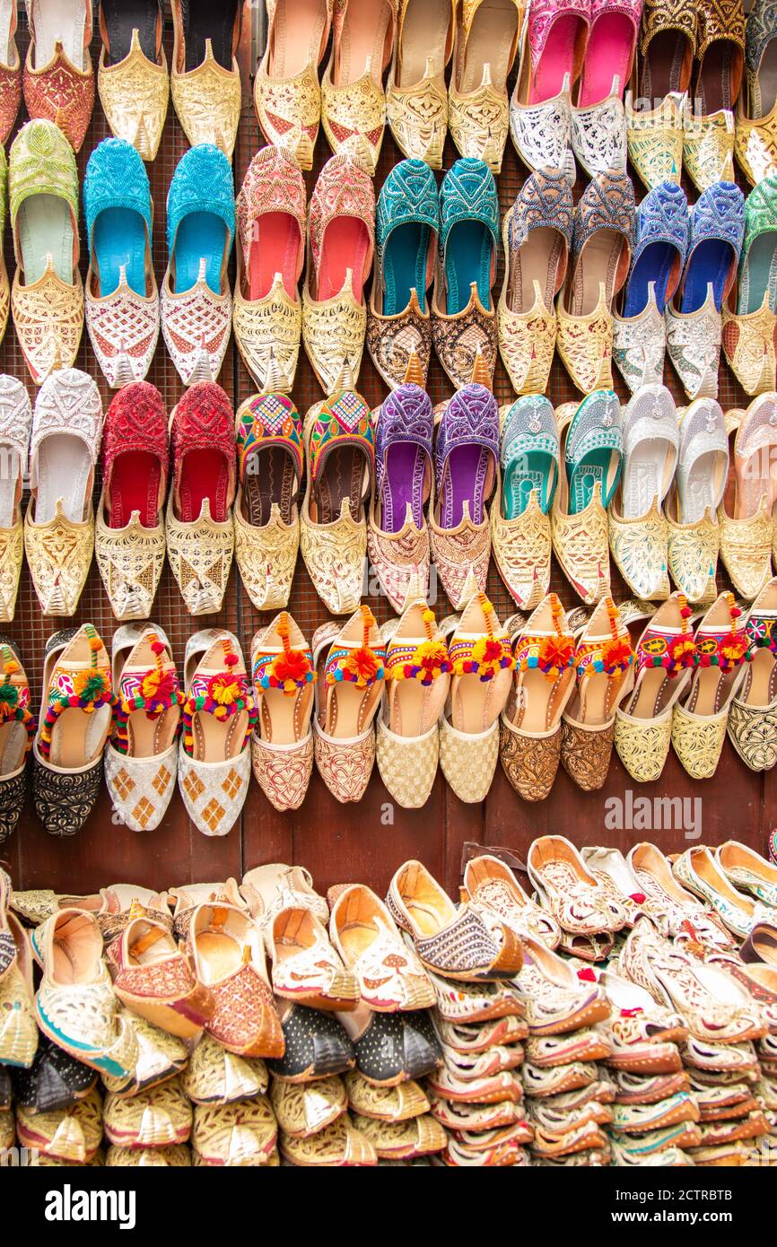 Shoe vendor displaying his colorful wares at one of the many souks in ...