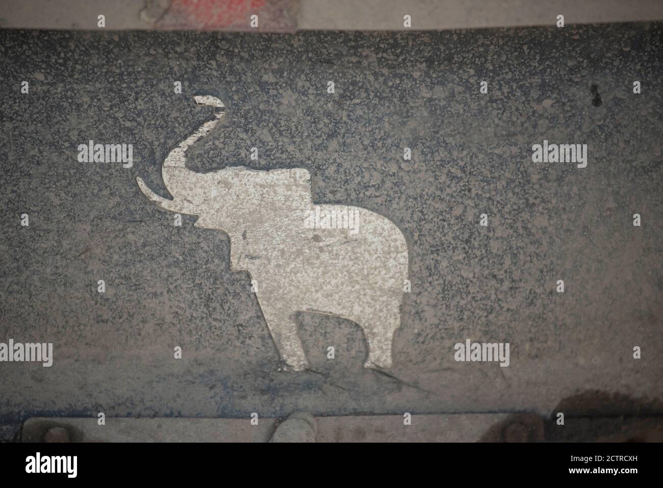symbol of an elephant with trunk and head up on the street Stock Photo ...