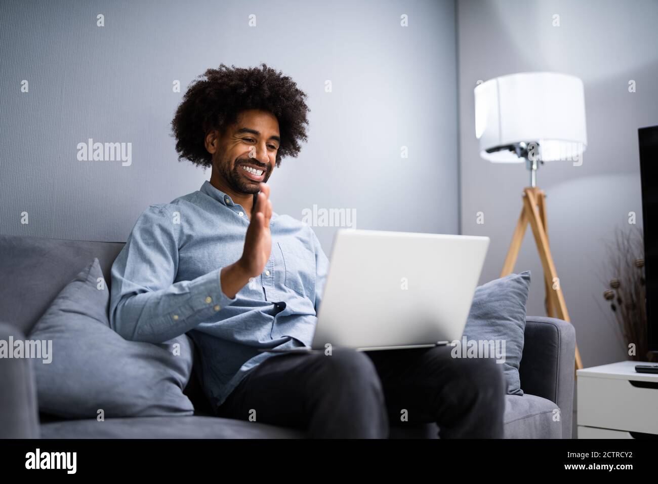 African Man Video Recording On Laptop At Home Stock Photo - Alamy