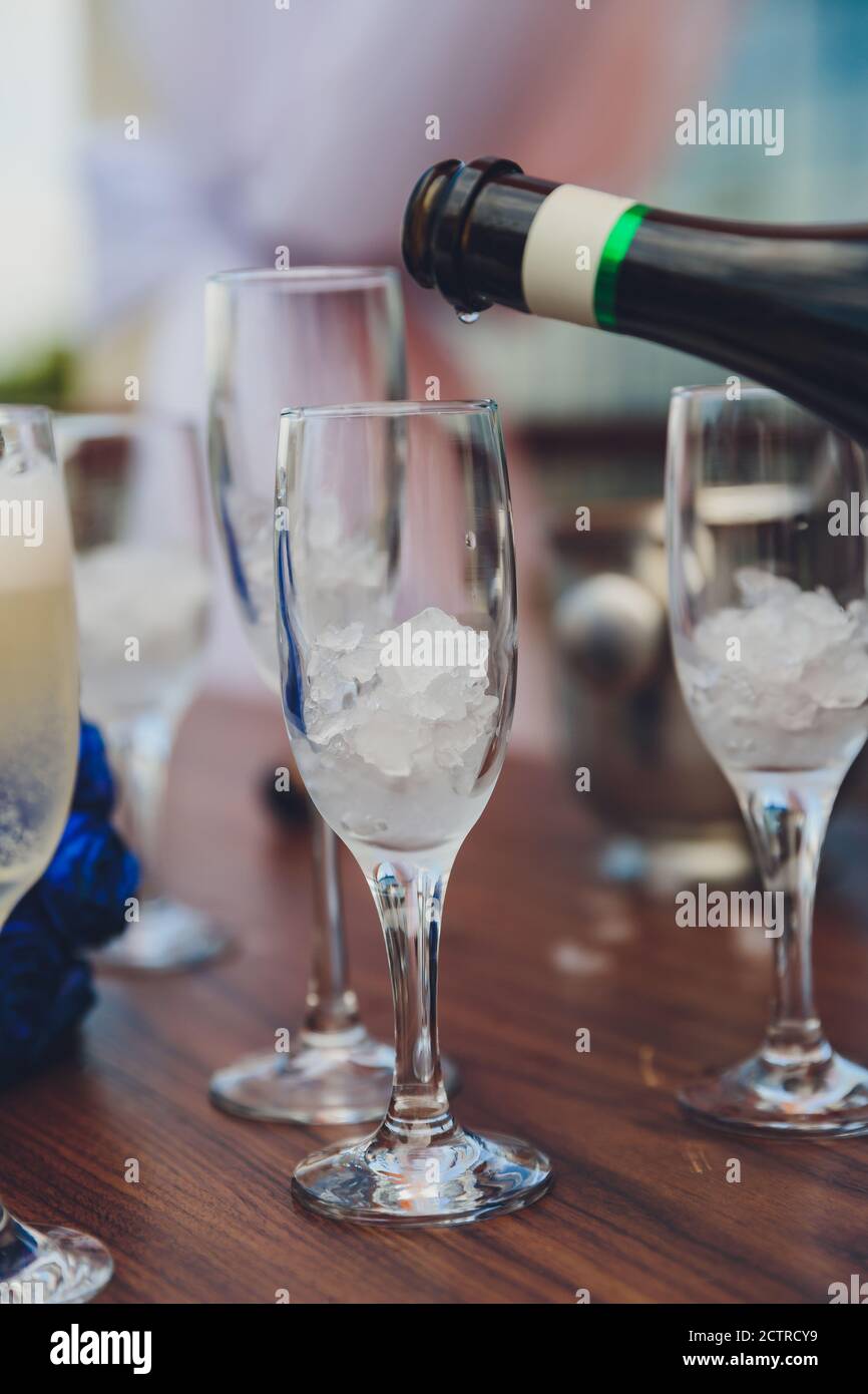 the process of pouring champagne into a glass Stock Photo - Alamy