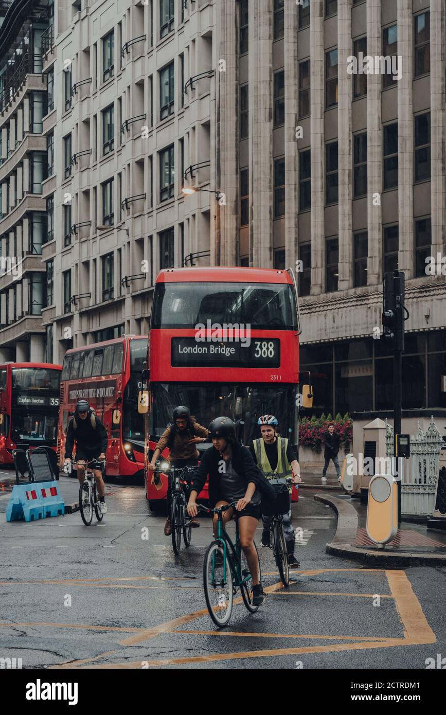 London, UK - August 24, 2020: Cyclists and red double decker buses in ...
