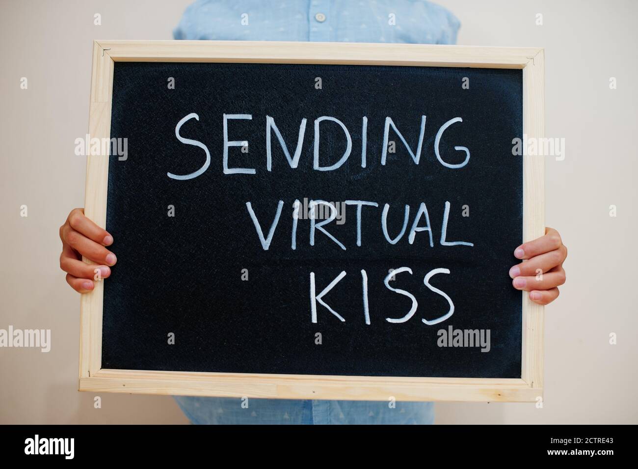 Sending virtual kiss. Coronavirus concept. Boy hold inscription on the ...