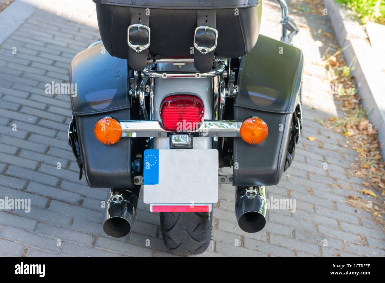 Closeup of the back of a modern motorcycle parked outside under the ...