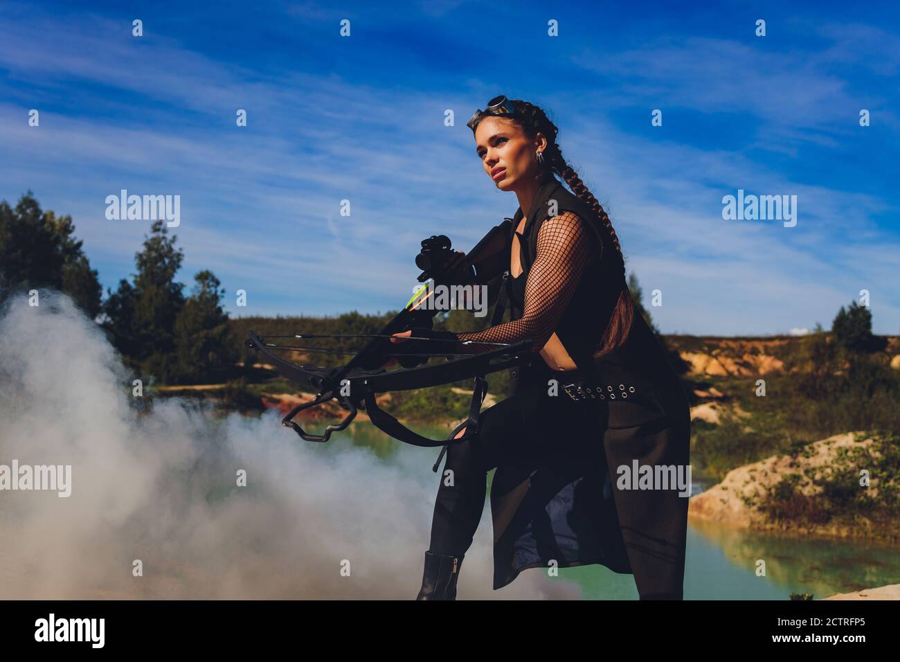 Athlete aiming Young woman holding the crossbow Stock Photo - Alamy
