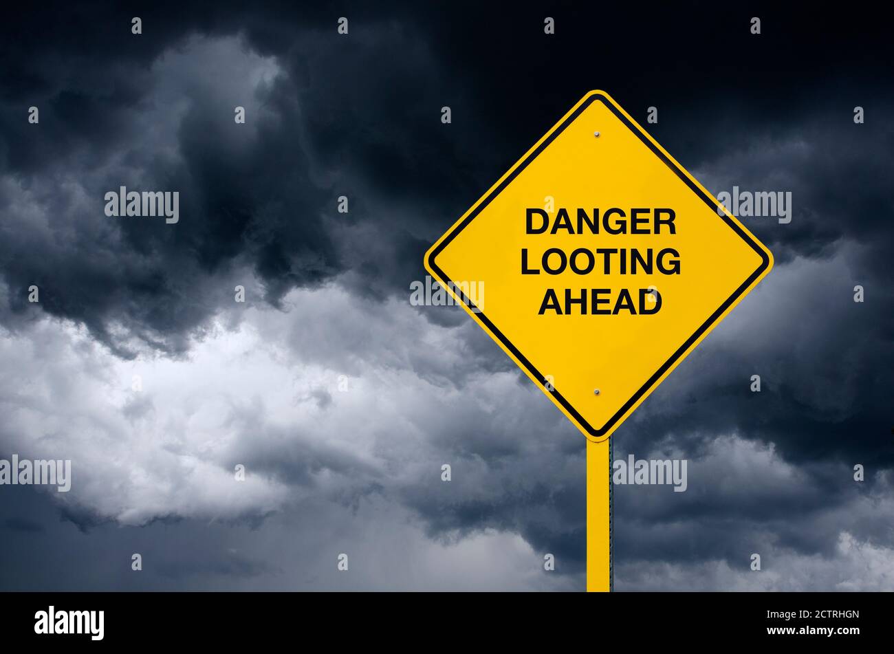 Danger Looting Ahead Road Sign in front of dark storm clouds Stock ...