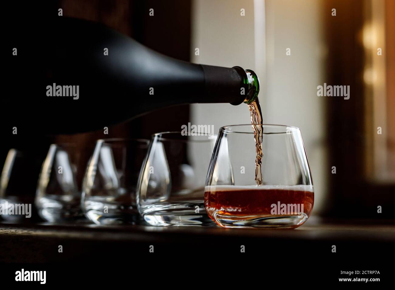 pouring cider into glass Stock Photo - Alamy