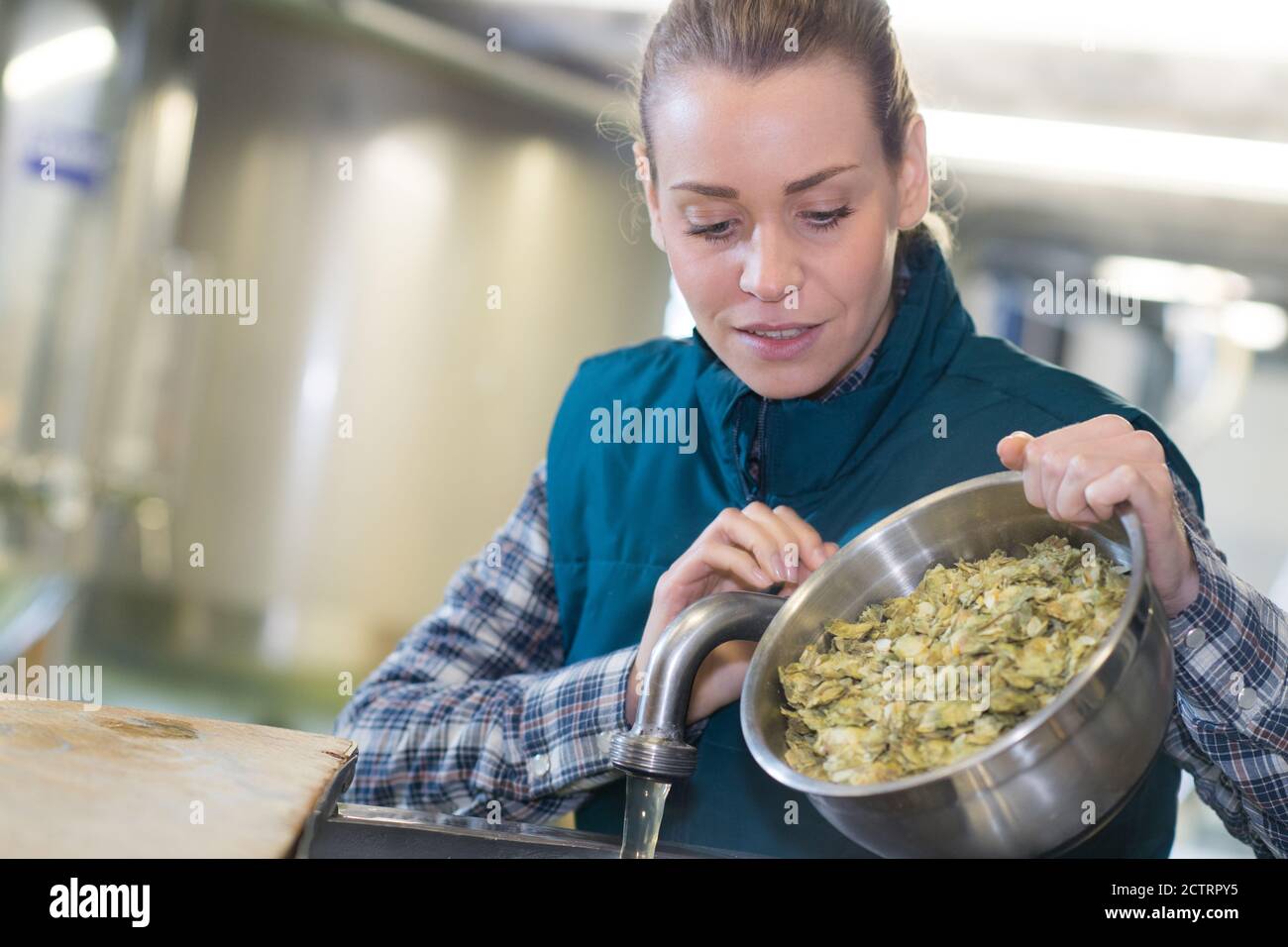portrait of efficient female with containers inside factory Stock Photo ...