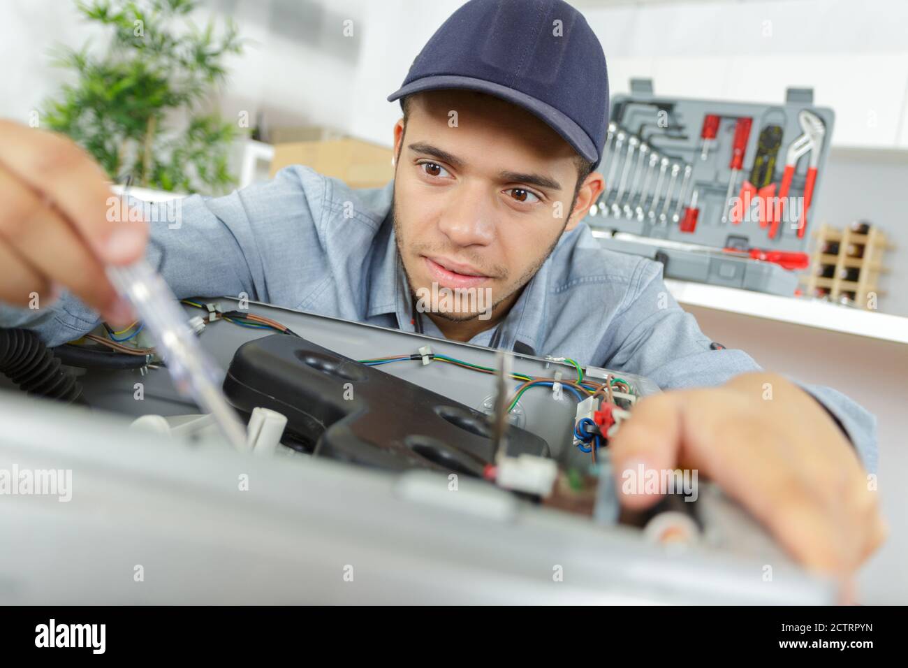a man fixing a machine working hands Stock Photo - Alamy