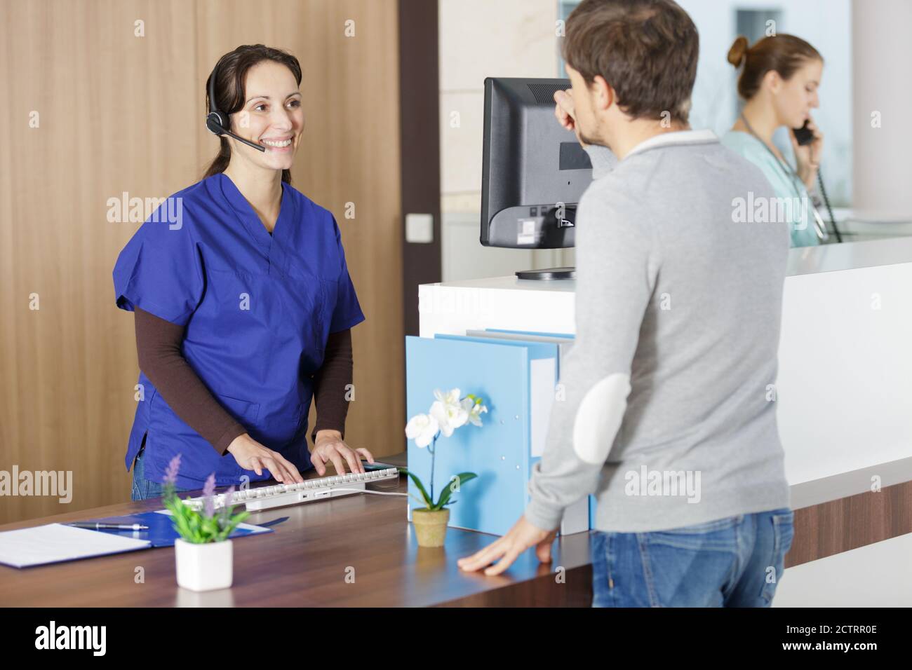 happy doctor at hospital reception Stock Photo - Alamy