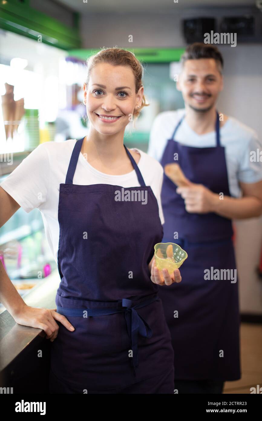 worker working with coworker at counter in ice cream parlor Stock Photo ...