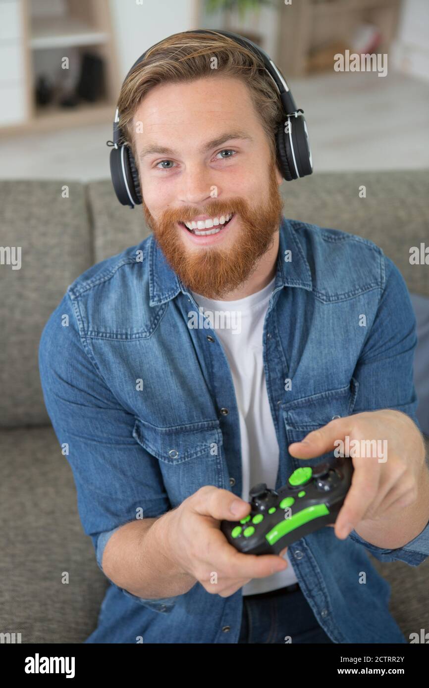 man having fun with computer game while wearing headphones Stock Photo ...