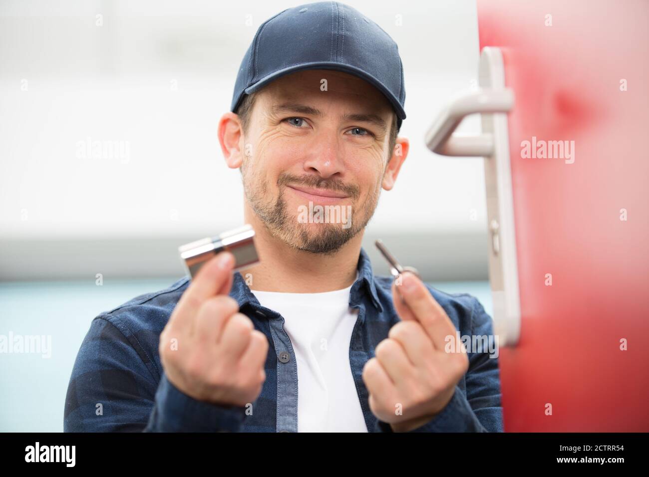 close-up of man holding door lock and key Stock Photo - Alamy