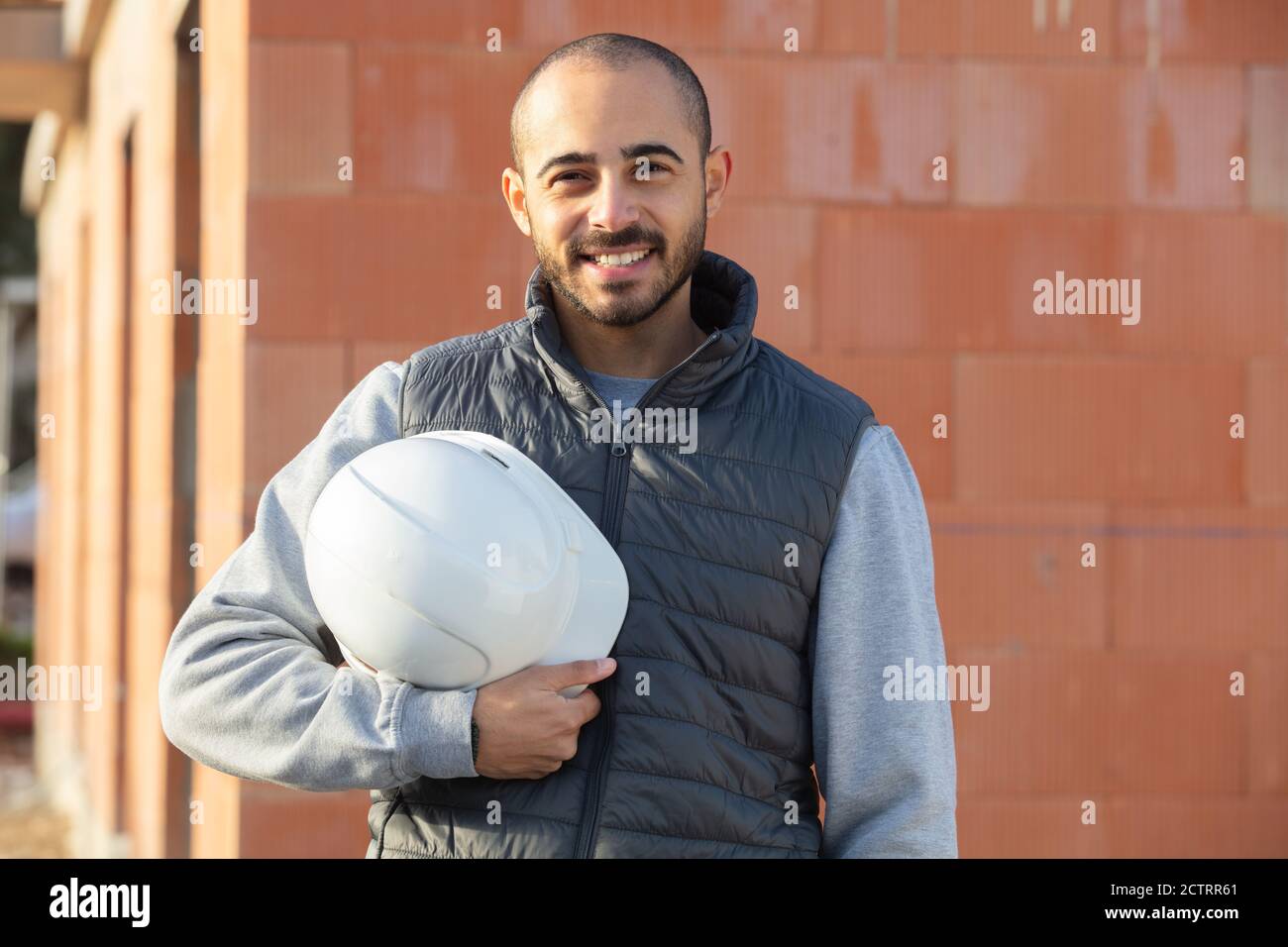 Engineer protective helmet holding hands hi-res stock photography and ...