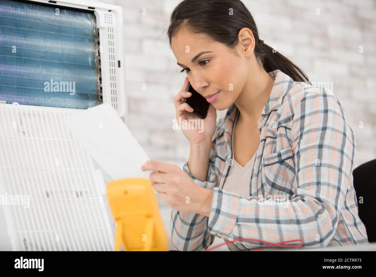 female technician making telephone call Stock Photo - Alamy