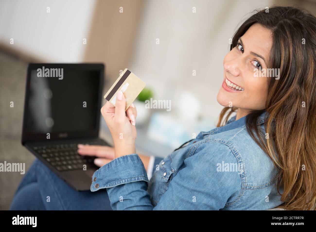 Girl making online payment holding hi-res stock photography and images ...