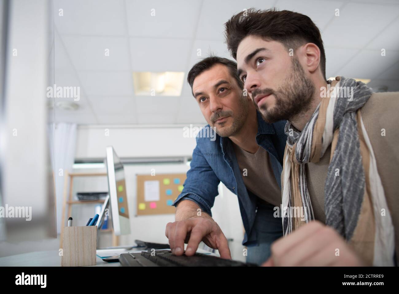 teacher helping student on the computer Stock Photo - Alamy