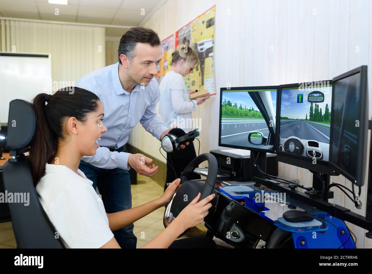 driving teacher supervising student on the simulator Stock Photo - Alamy