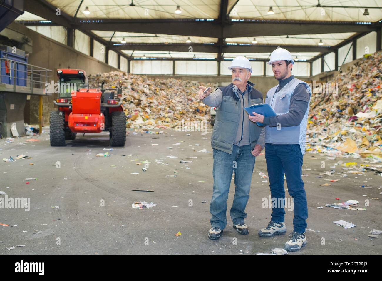 male workers planning in recycling center Stock Photo - Alamy