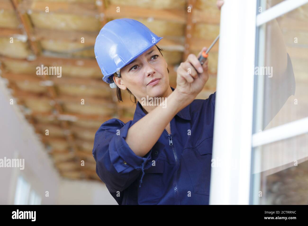 woman fixing old wooden white window panel Stock Photo - Alamy
