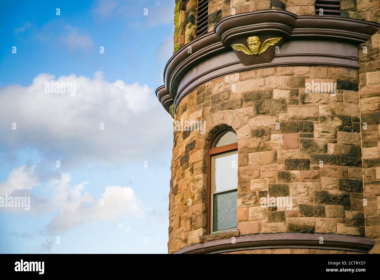 Old round corner turret made of stone, with arch topped "radius" window ...