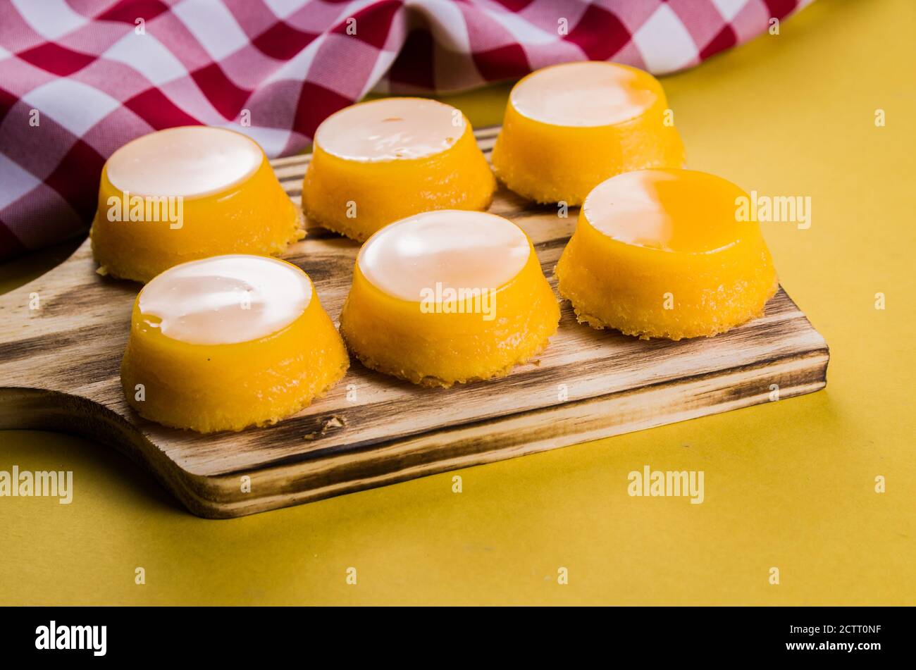 Delicious Quindins on wooden board, traditional Brazilian dessert made ...