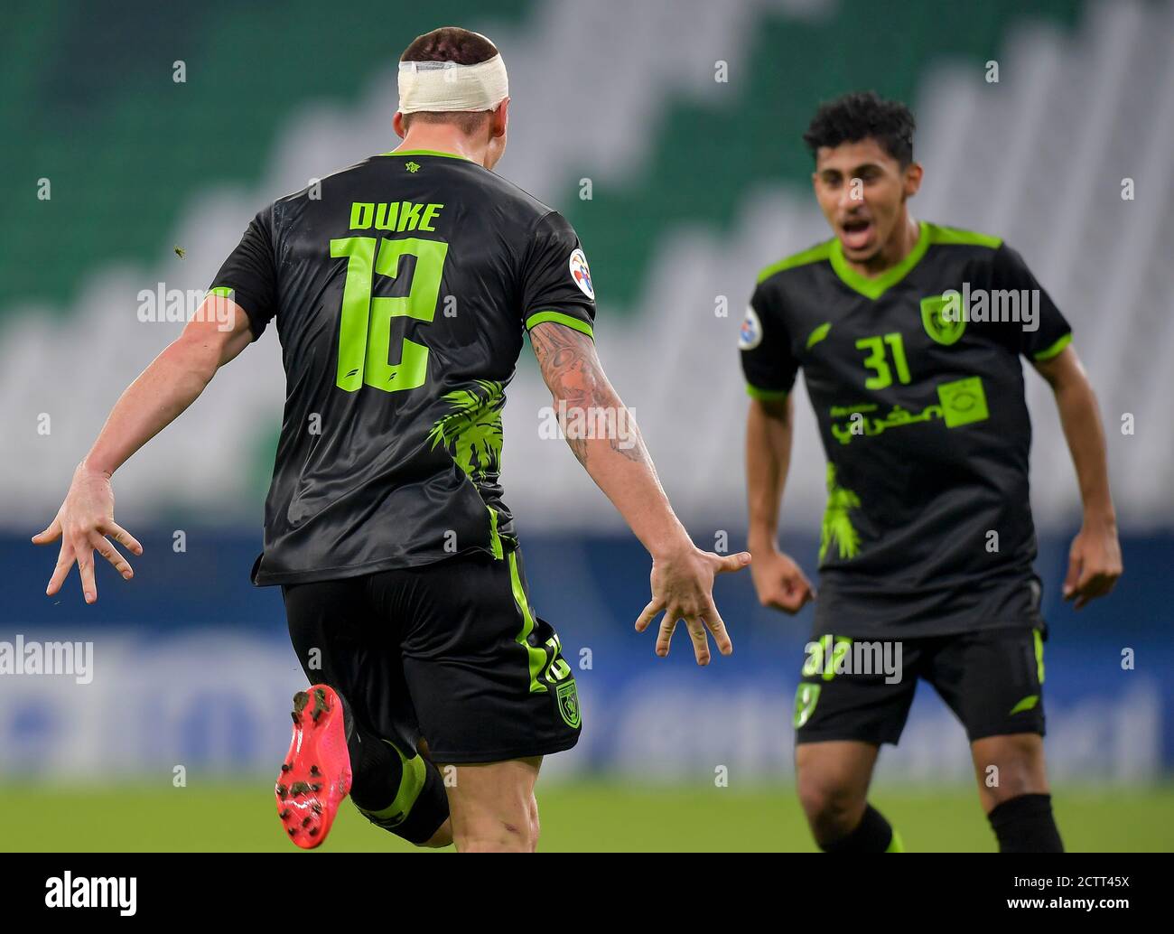 Doha, Qatar. 24th Sep, 2020. Mitchell Duke (L) of Taawoun FC celebrates ...